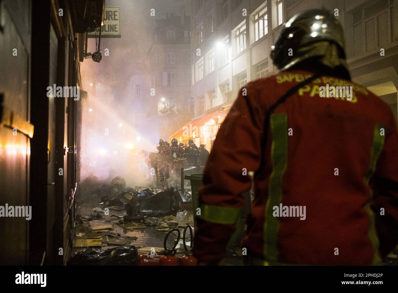 Paris, France. 23rd Mar, 2023. A firefighter tries to extinguish bags ...