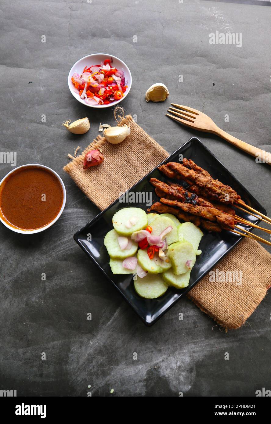 chicken satay or chicken satay served with lontong, rice cake and ...