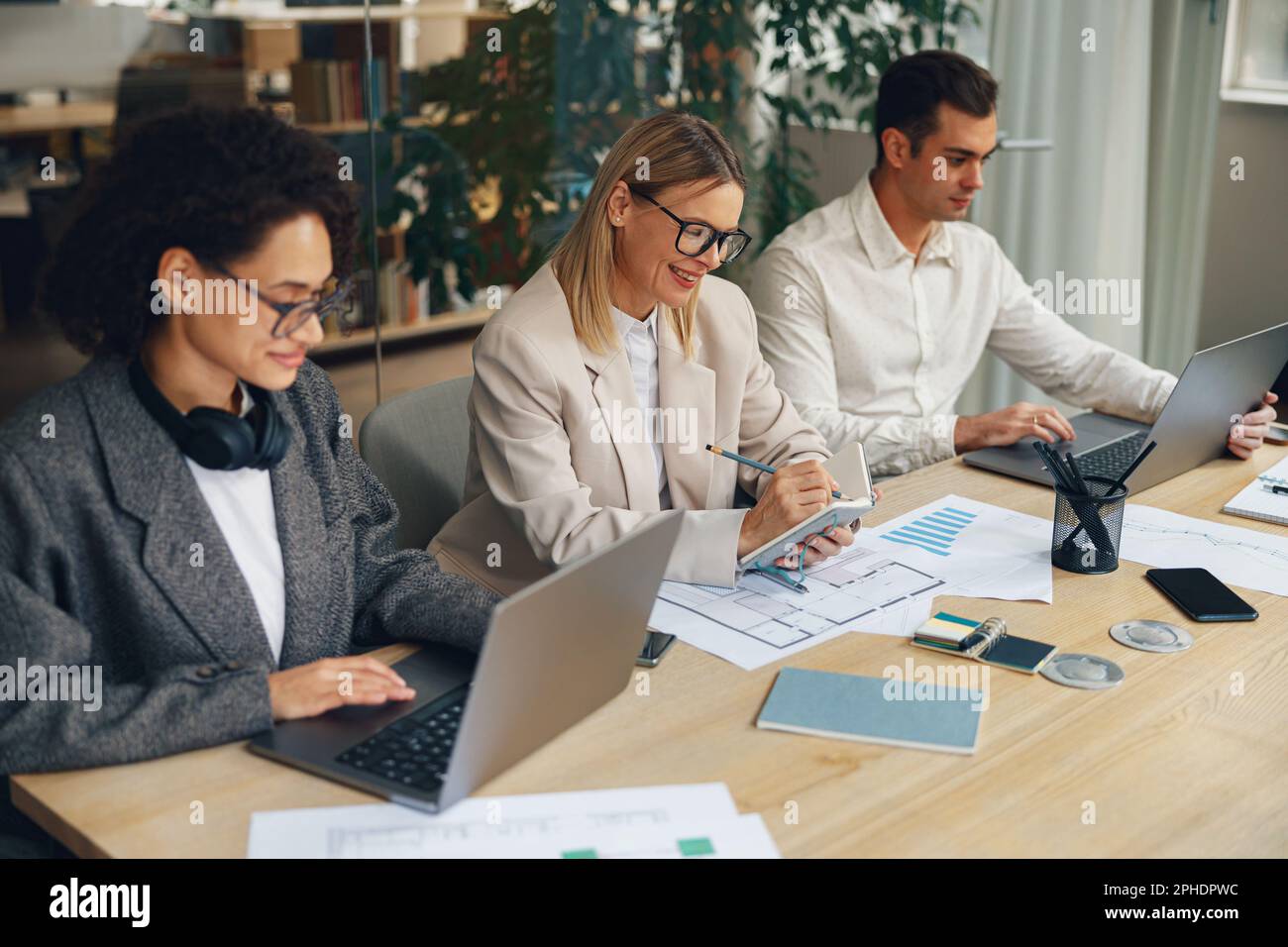 Business team is analysing new financial project while working together ...