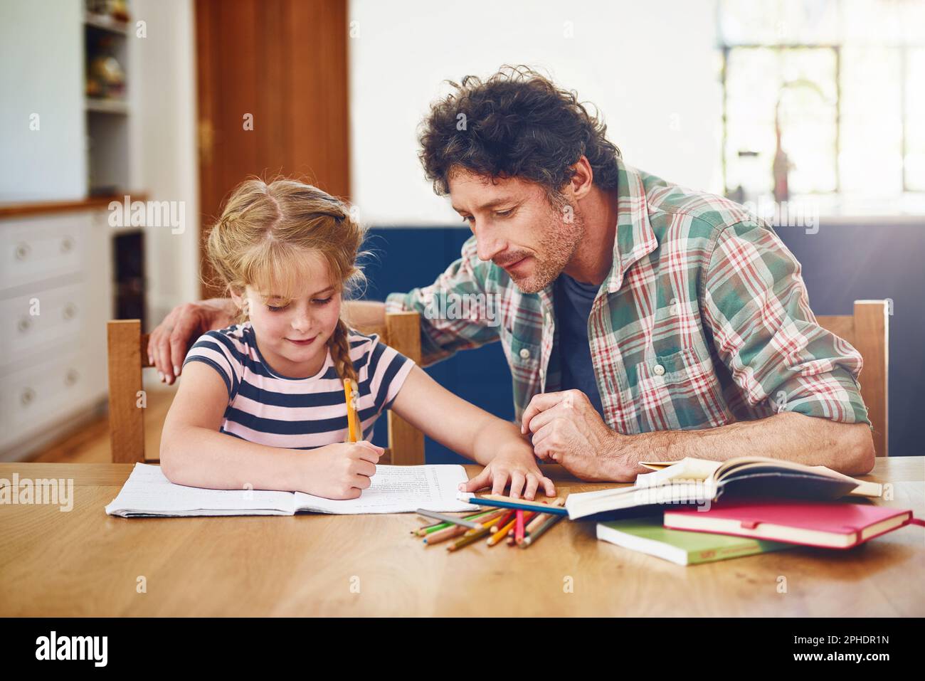 Dads highly involved in his daughters education. a father helping his ...
