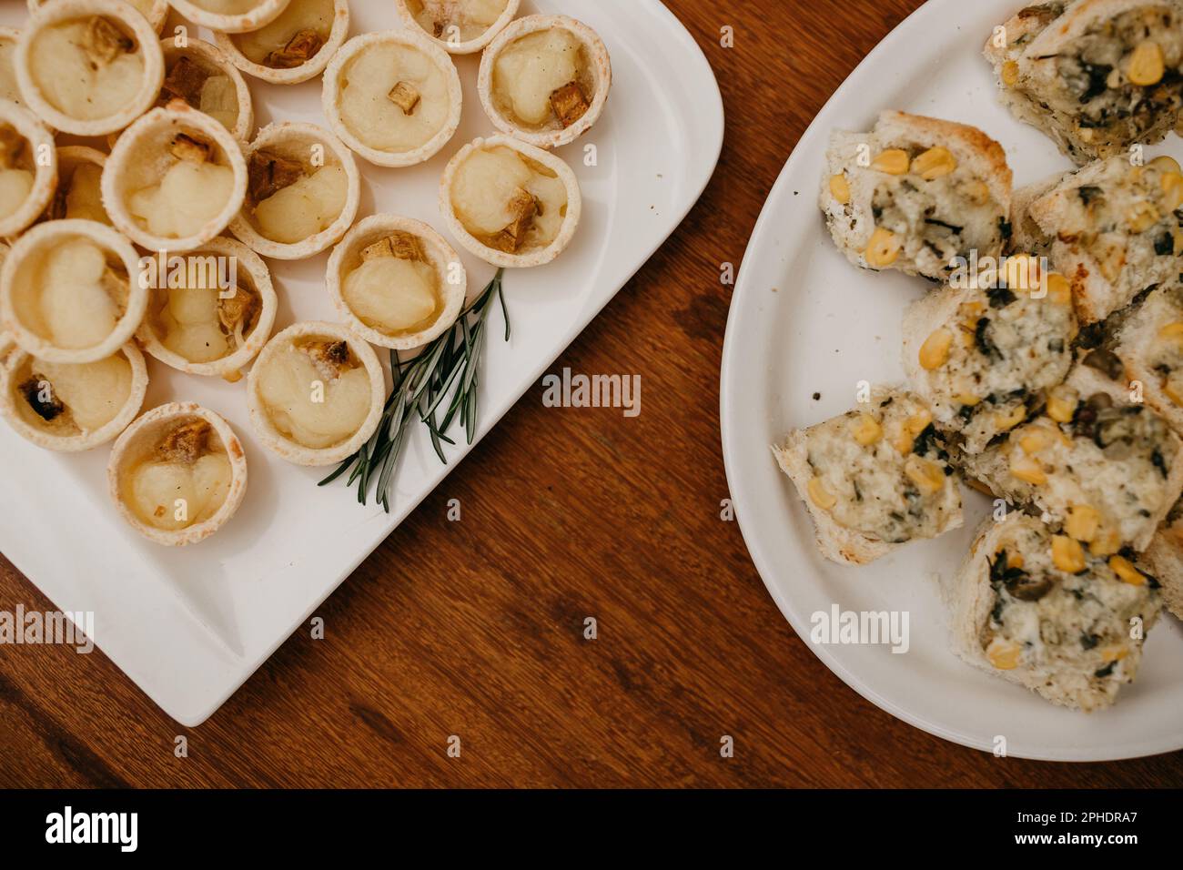 A wooden table displays a spread of two different types of food Stock ...