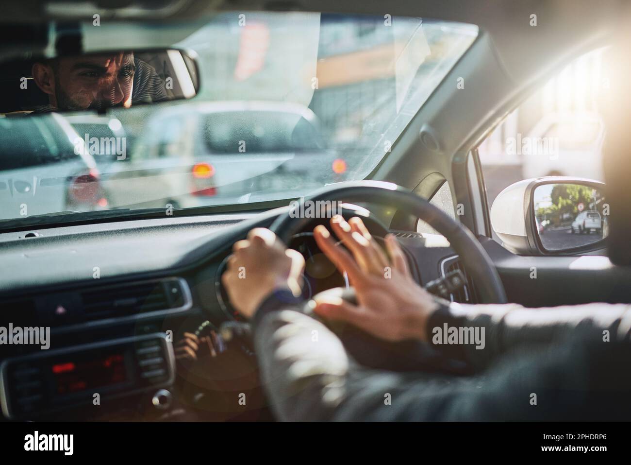 Sounding his annoyance on the road. a young man hooting while driving a ...