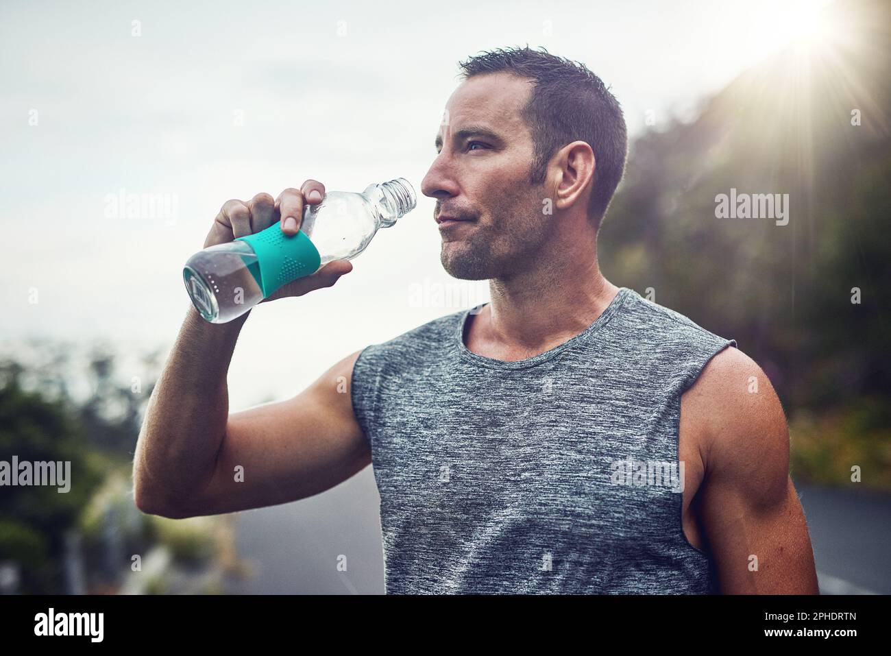 Refreshed and ready to run. a young handsome man training for a ...