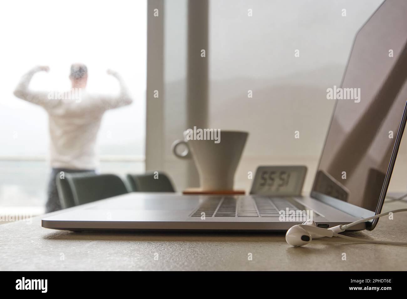 Digital nomad man finished work and celebrating on the balcony ...