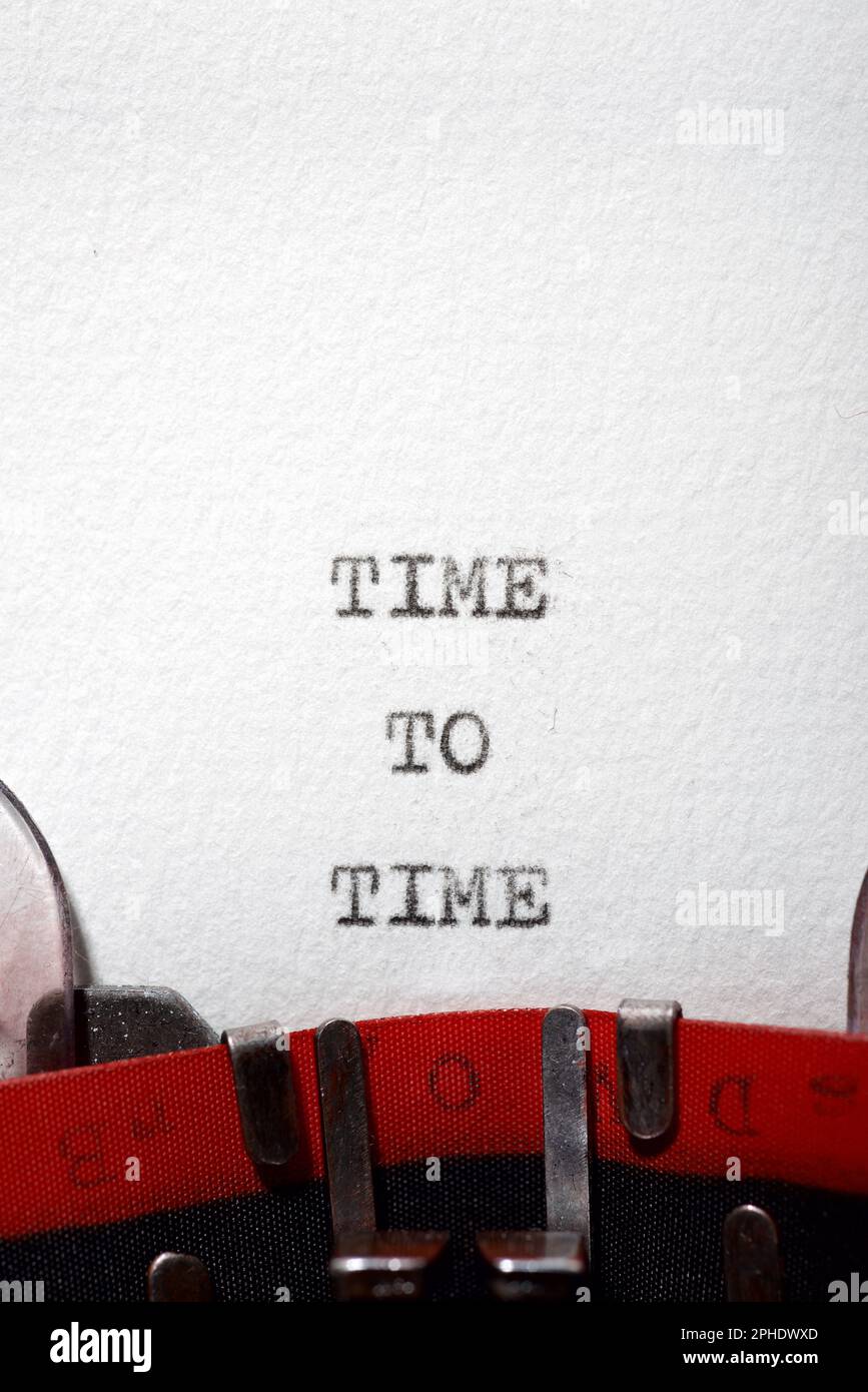 Time to time text written with a typewriter Stock Photo - Alamy
