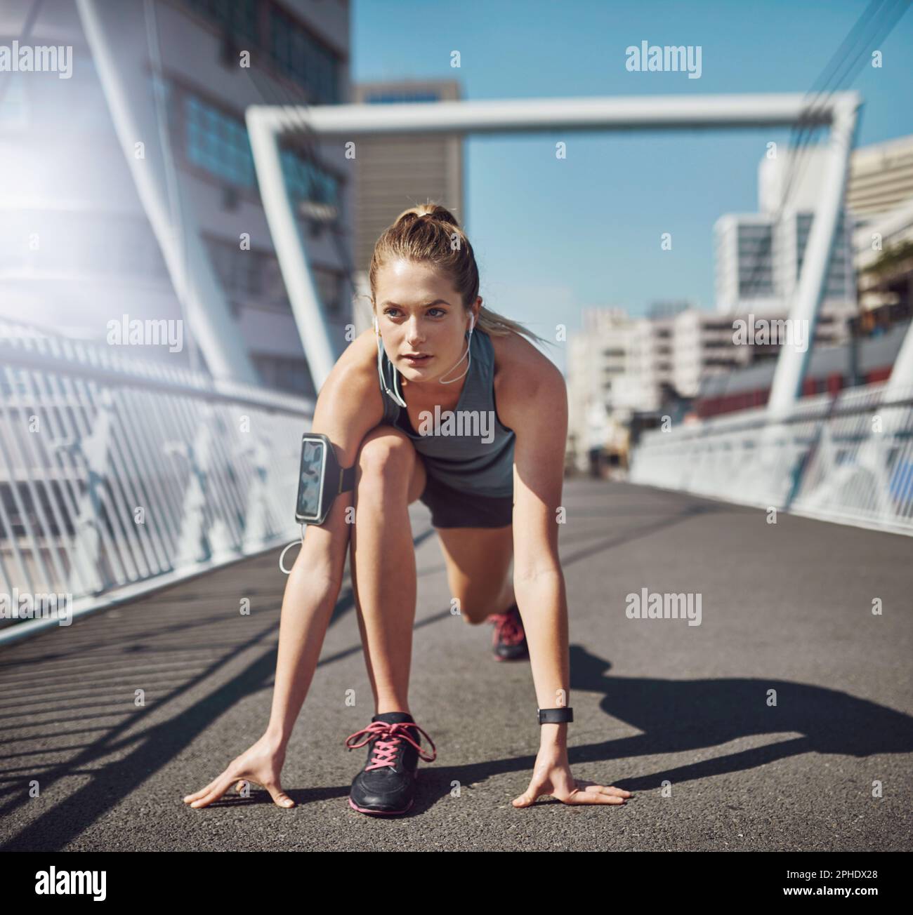 Steadily improving her fitness levels. a sporty young woman getting set ...