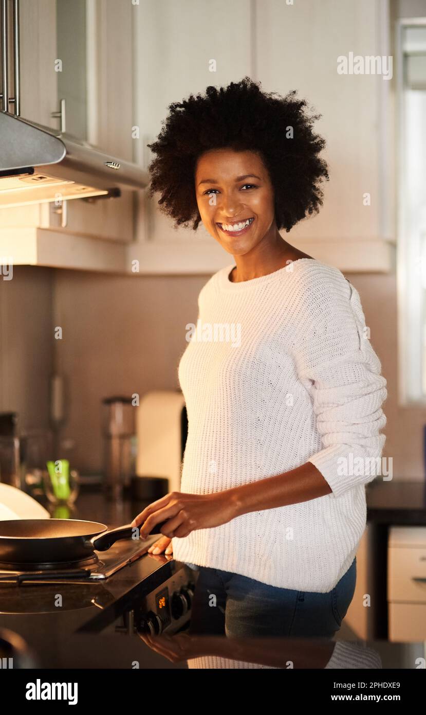 Good mornings start with great breakfasts. a young woman cooking at ...