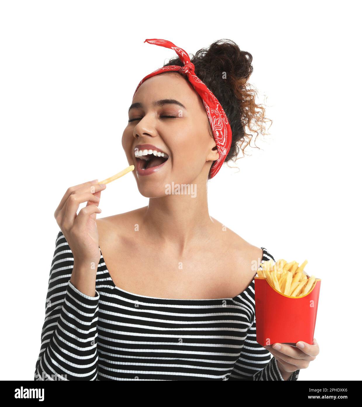 African American woman eating French fries on white background Stock ...