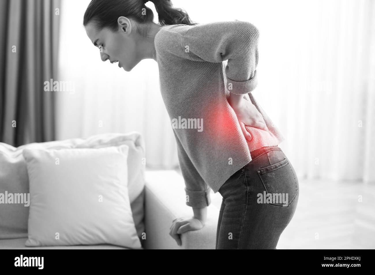 Woman suffering from back pain at home. Bad posture problem Stock Photo ...