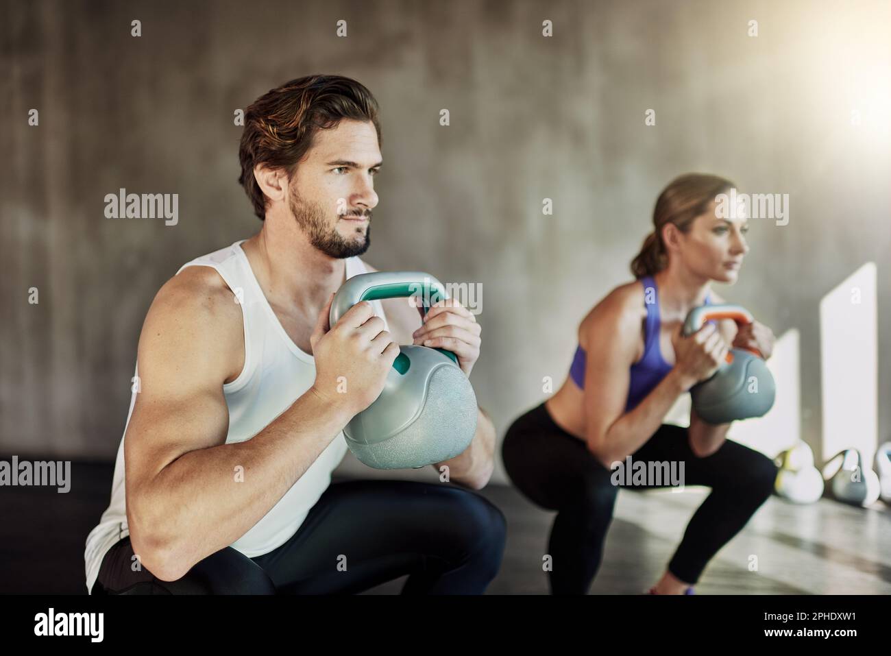 When nothing goes right go lift. two young people working out in the ...
