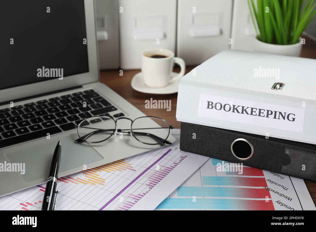 Folders, laptop and documents on desk in office. Bookkeeper's workplace ...