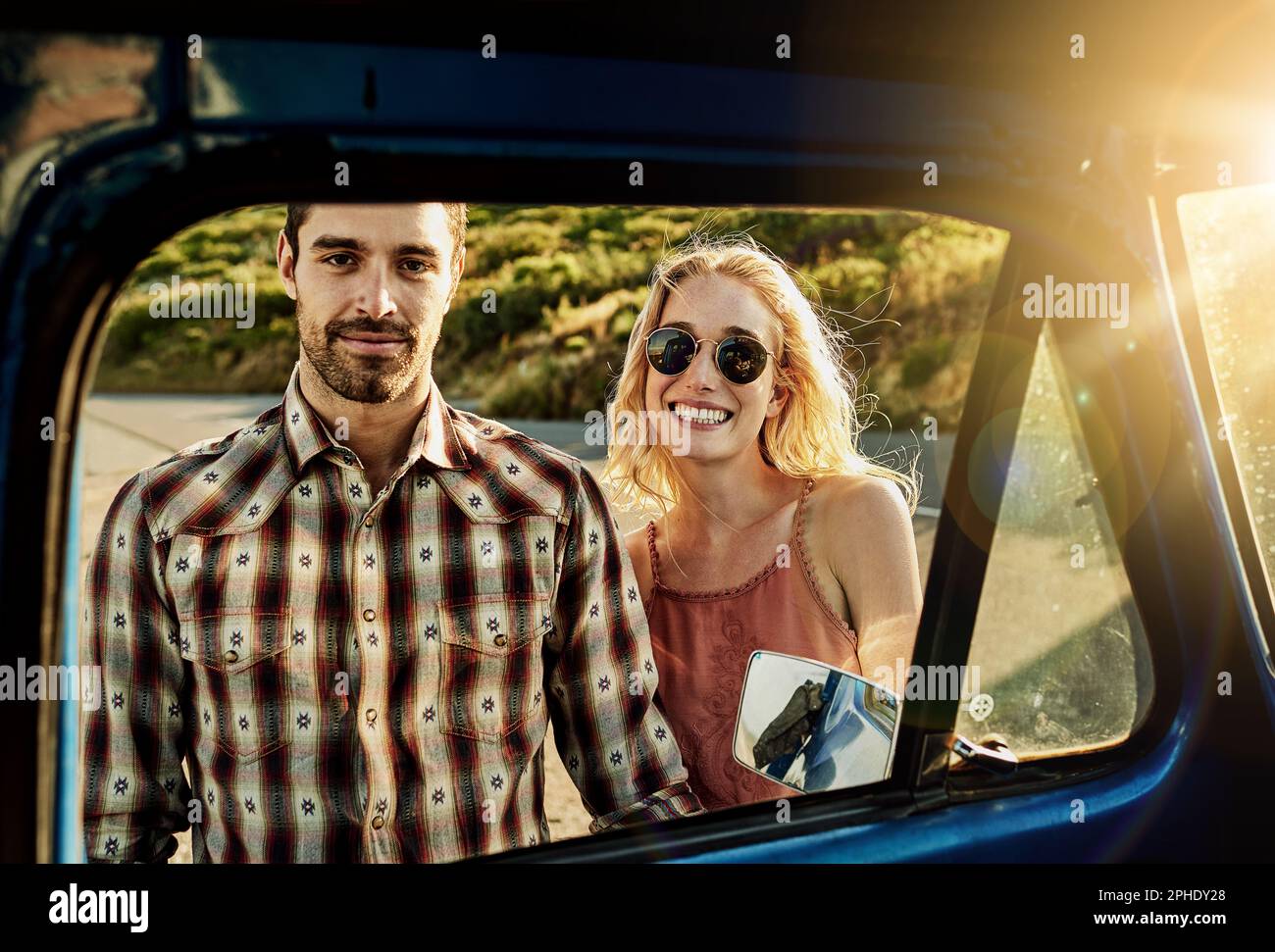 Take us anywhere. a couple couple standing by the window of a pickup ...