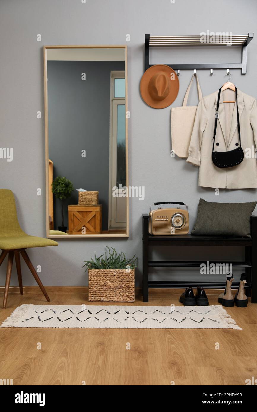 Modern hallway interior with stylish chair, shoe rack and mirror Stock ...