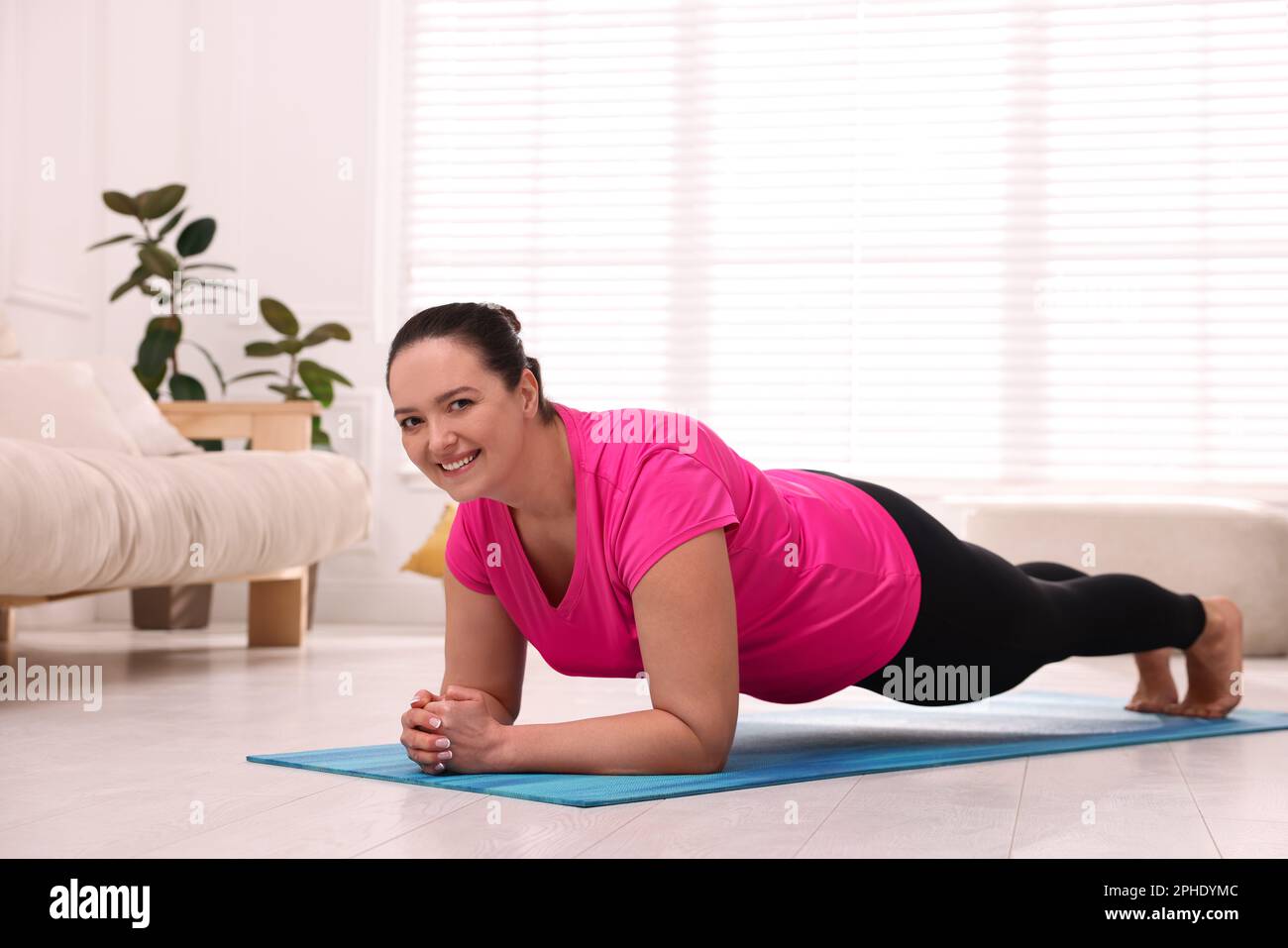 Overweight woman doing plank hi-res stock photography and images - Alamy