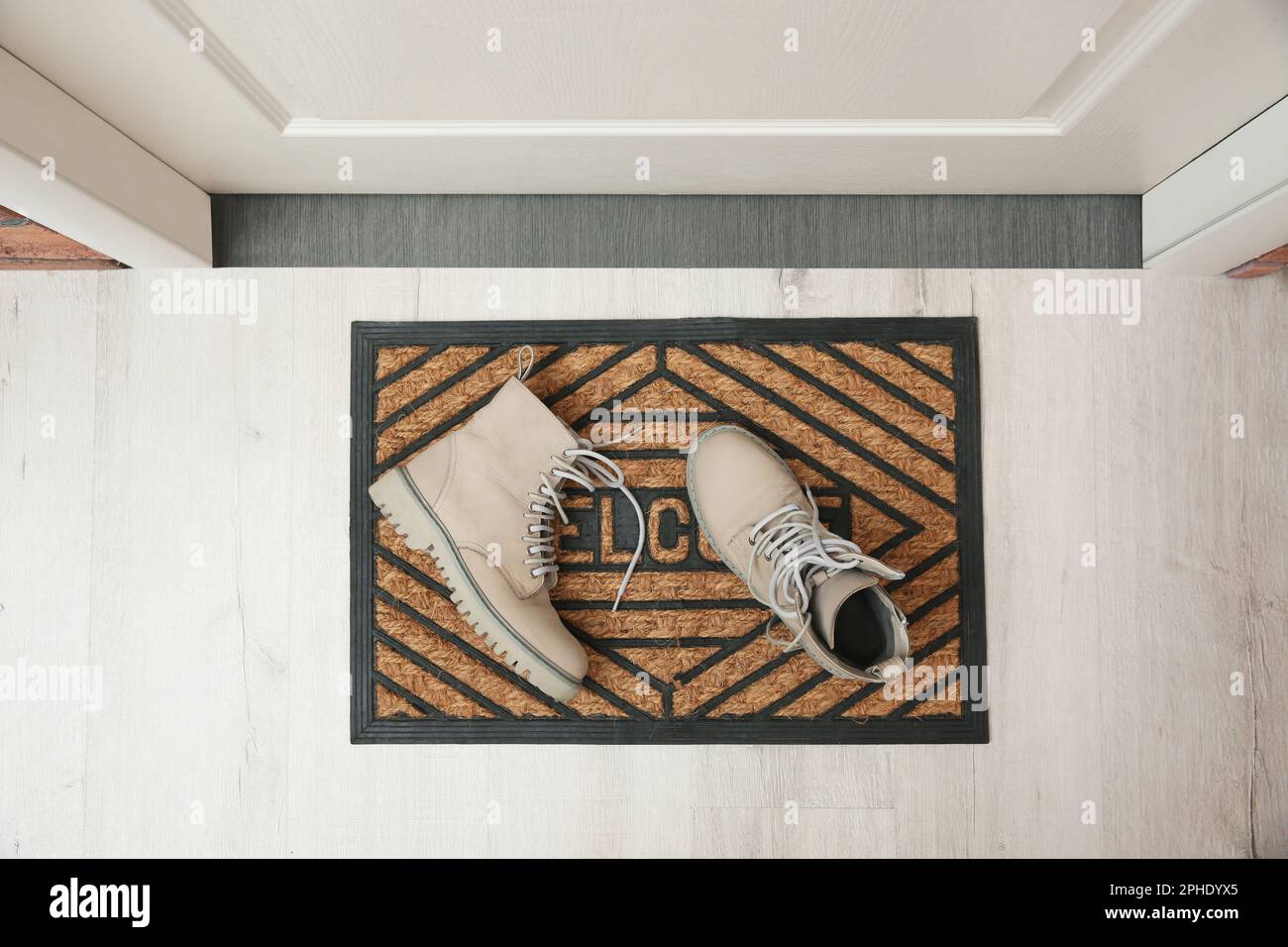 Shoes on door mat hi-res stock photography and images - Alamy