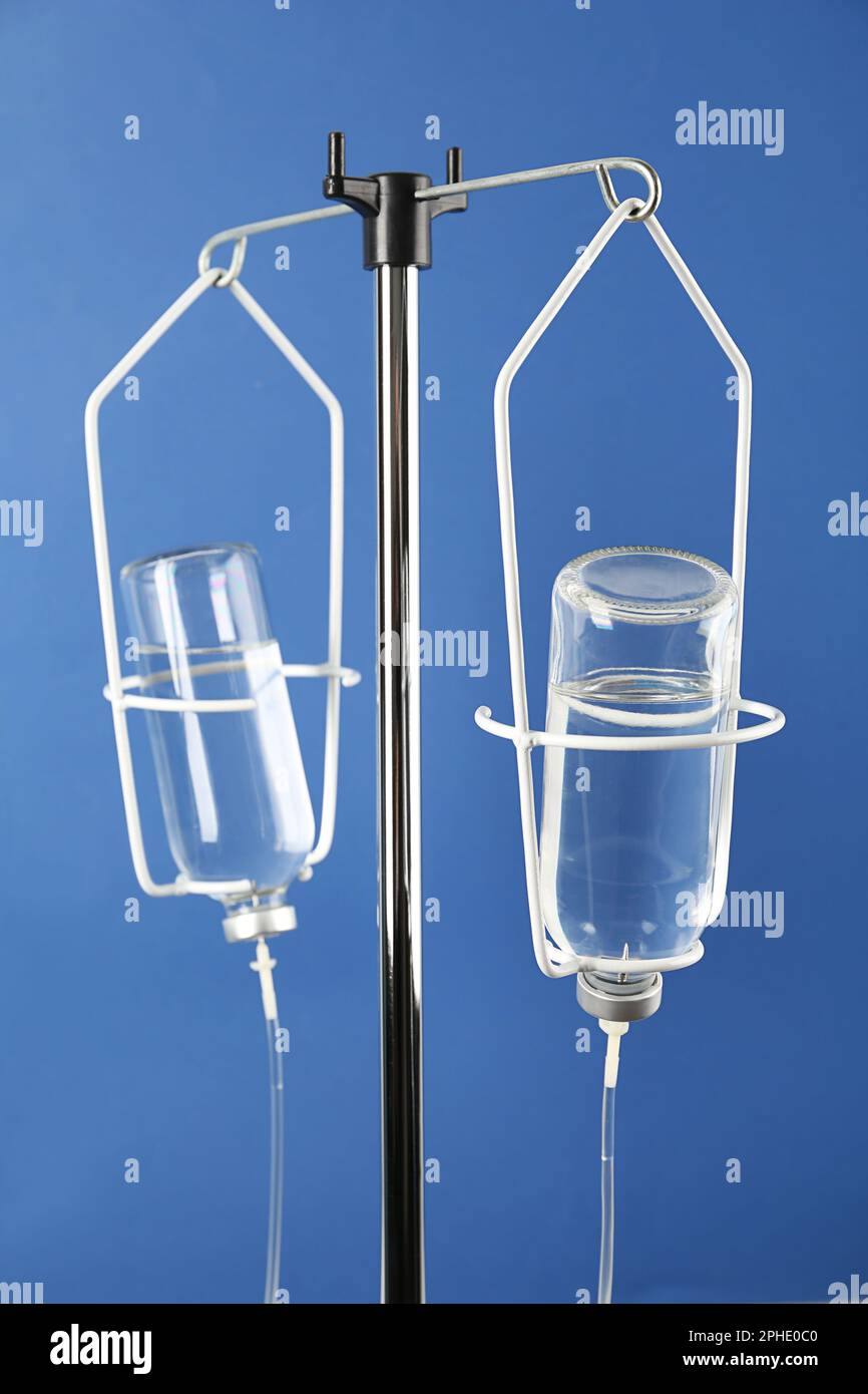 Infusion set on blue background. Intravenous therapy Stock Photo - Alamy