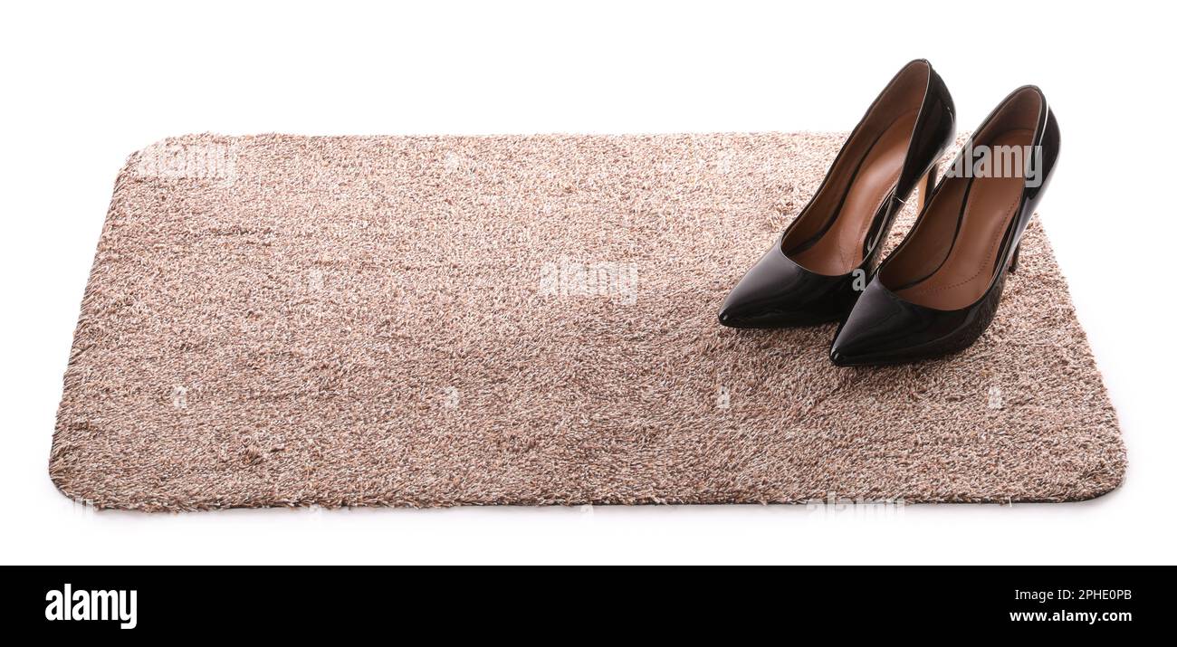 Stylish door mat with high heeled shoes on white background Stock Photo ...