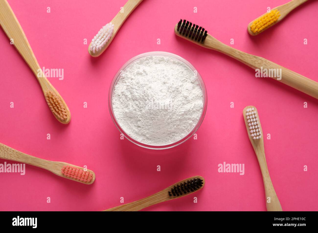 Bowl of tooth powder and brushes on pink background, flat lay Stock ...