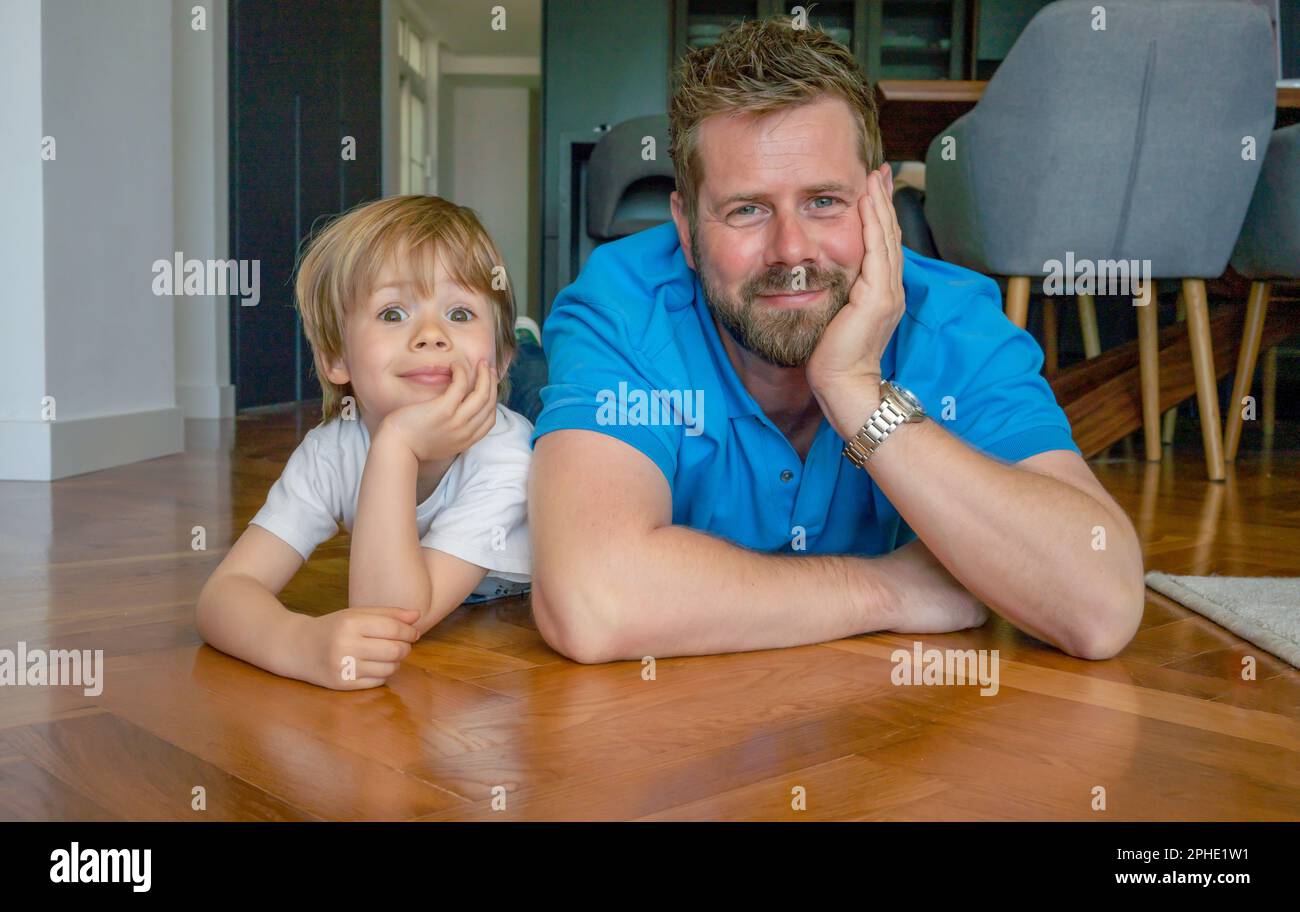 Parents and children being friends. Joyful father and son having fun ...