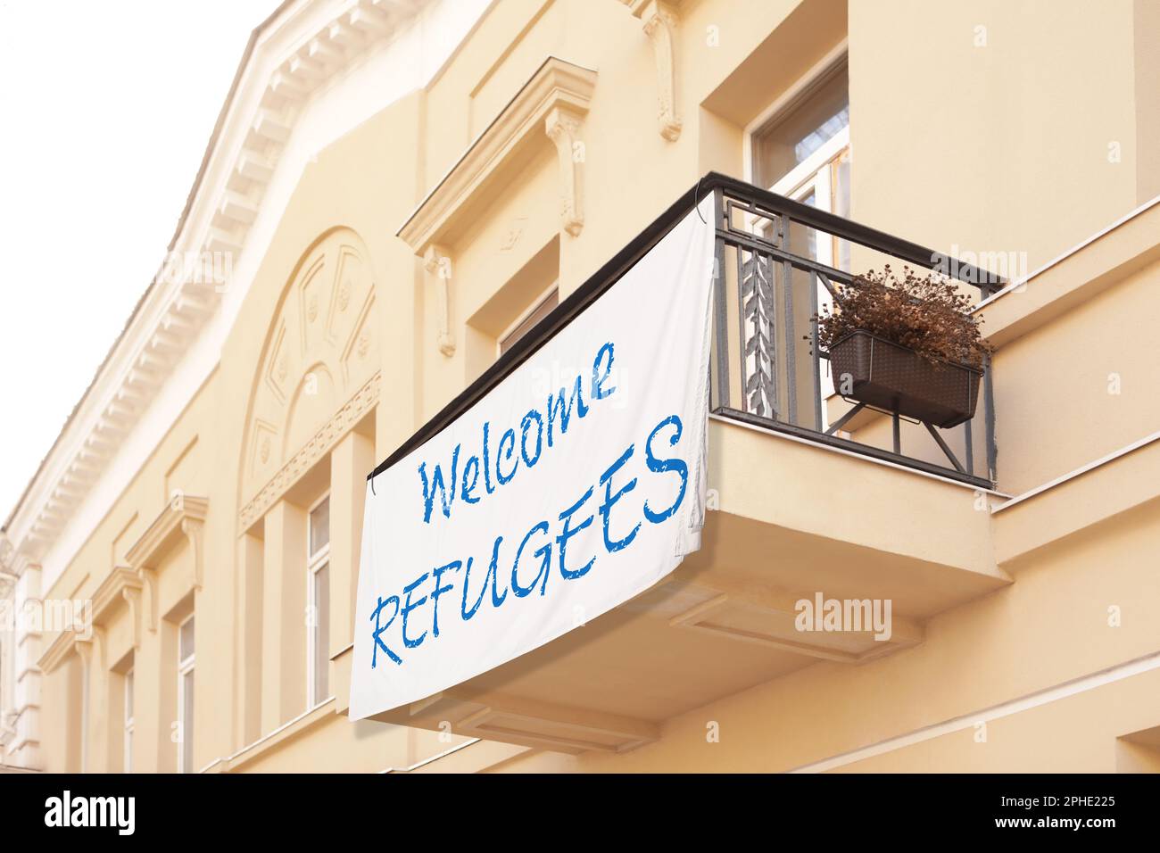 Banner with phrase WELCOME REFUGEES on building outdoors Stock Photo ...