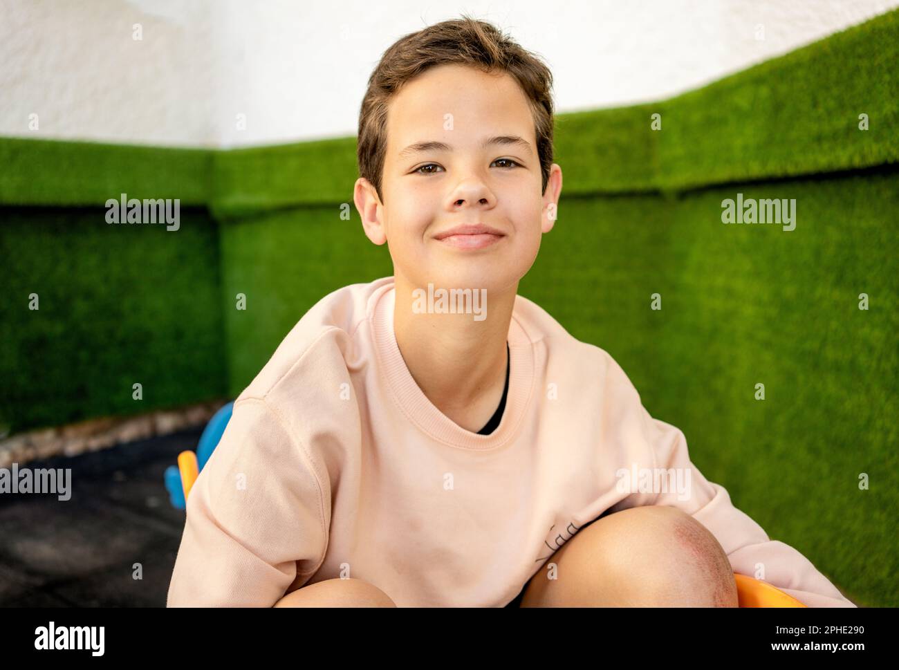 Portrait of attractive happy smiling 11 years old boy, outdoor over ...