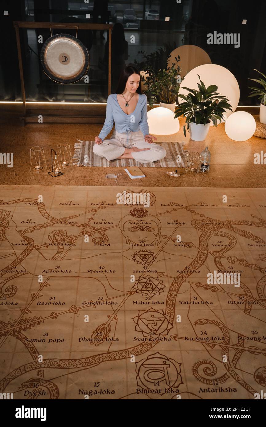 A young woman sits in the lotus position before the start of the game ...