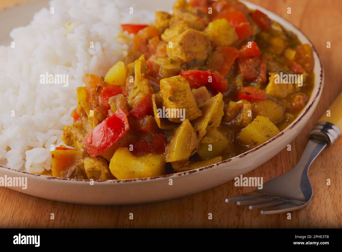 Indian styled curry with potatoes,chicken and rice Stock Photo - Alamy