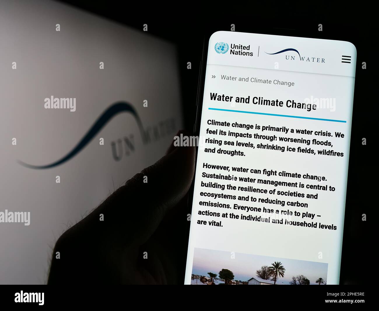 Person holding cellphone with webpage of agency United Nations Water ...