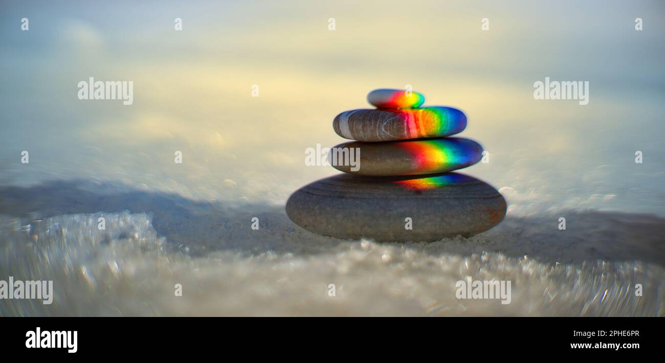 Early spring Zen rainbow stone on ice. Concept of onset of spring Stock ...