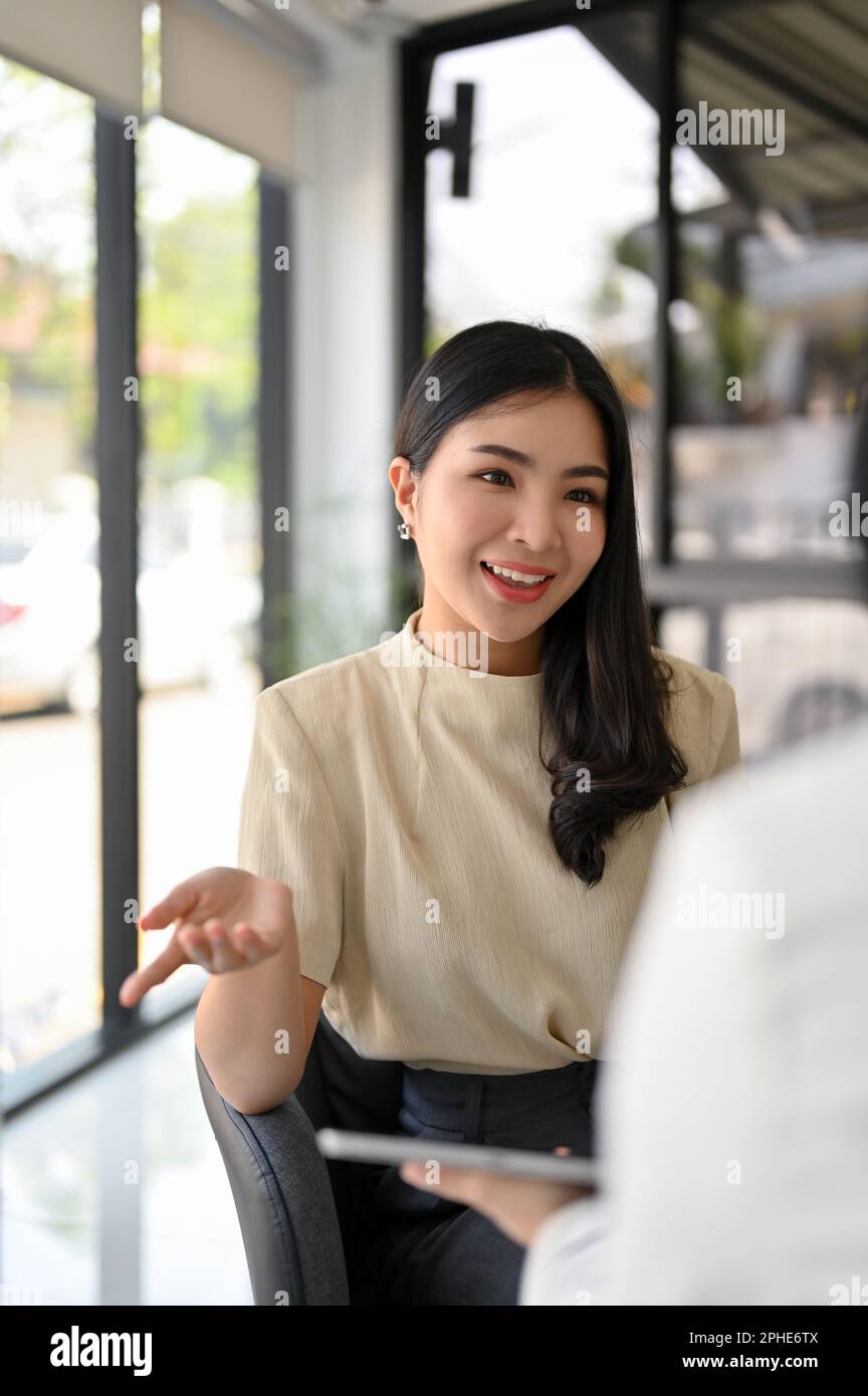 Portrait of a beautiful and attractive millennial Asian female boss ...