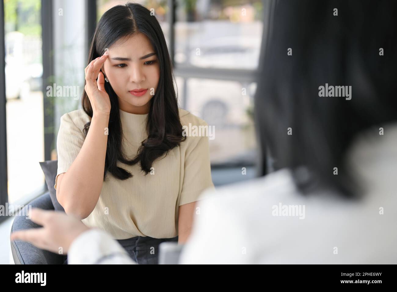 Stressed and thoughtful millennial Asian woman feeling dizzy and ...