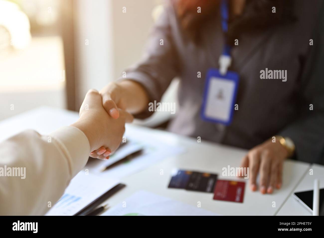 Cropped image of a professional and successful female banker shaking ...