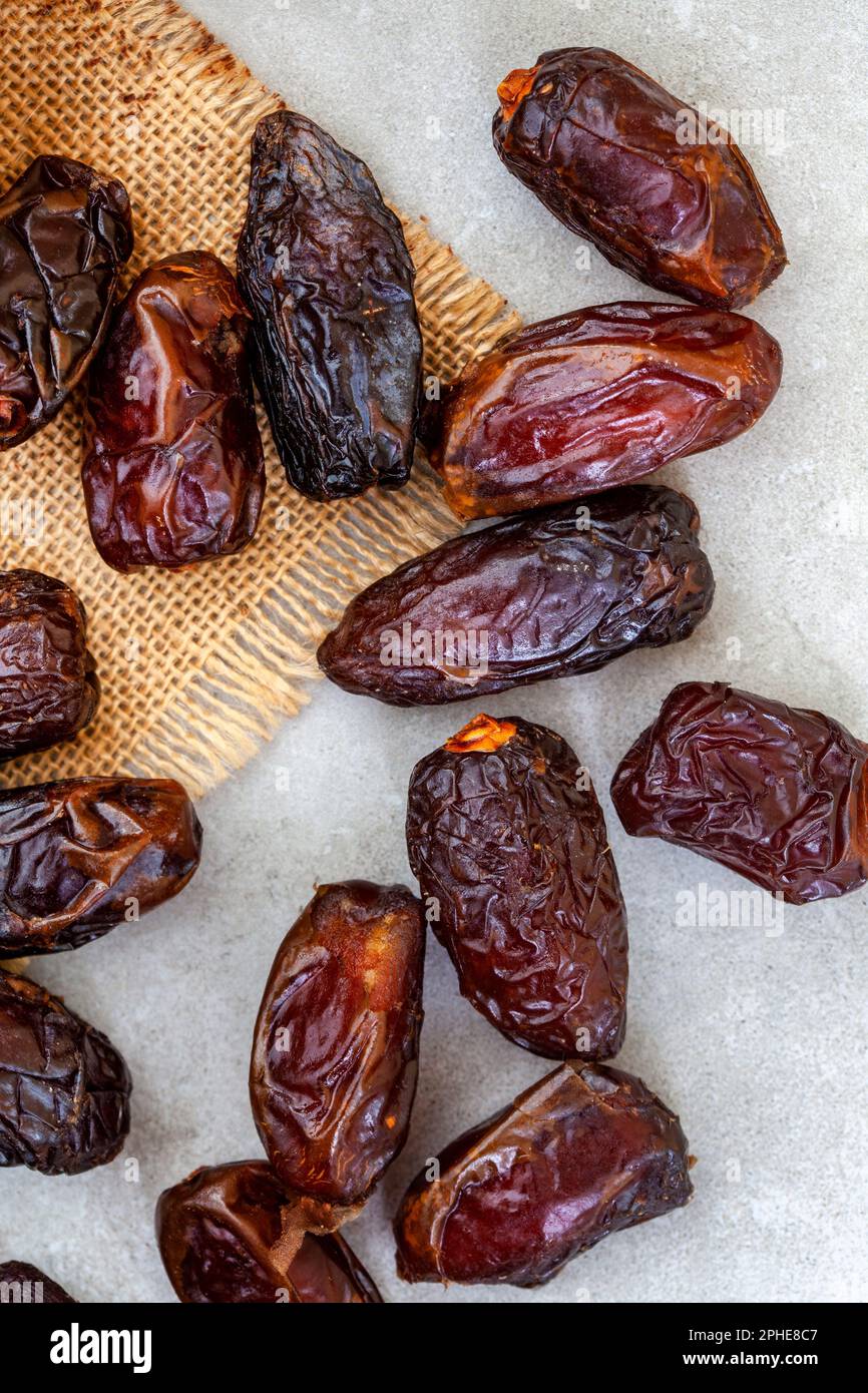 Dried dates on rustic grey surface Stock Photo - Alamy