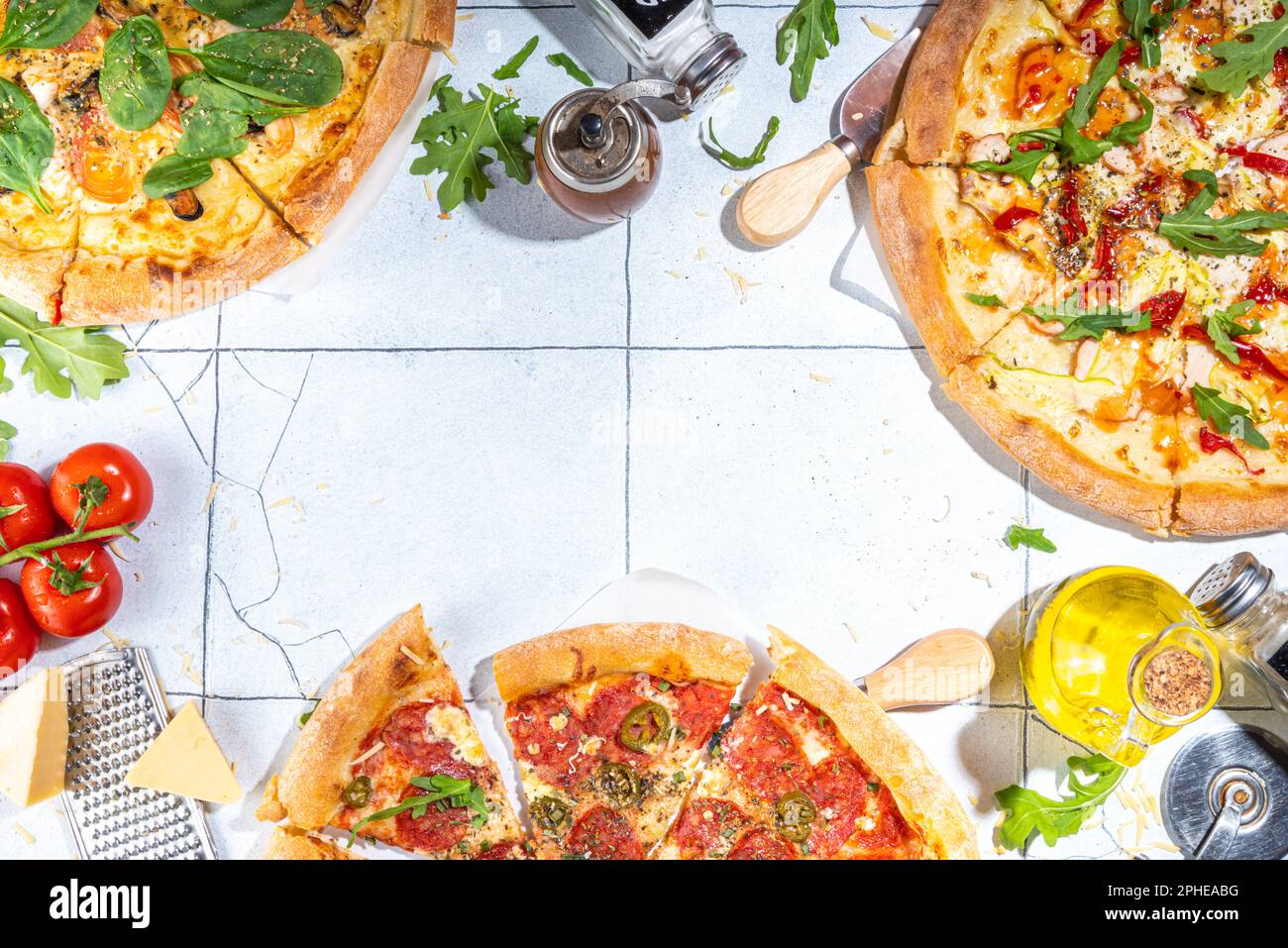 Three various pizzas, served at home or in restaurant on tiled table ...