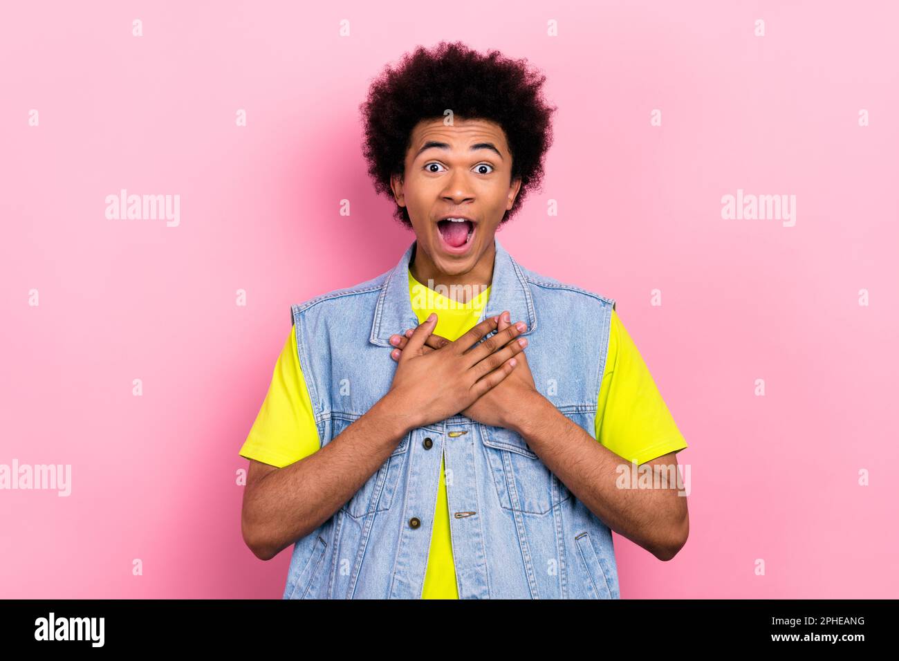 Photo of astonished positive young man open mouth arms touch chest ...