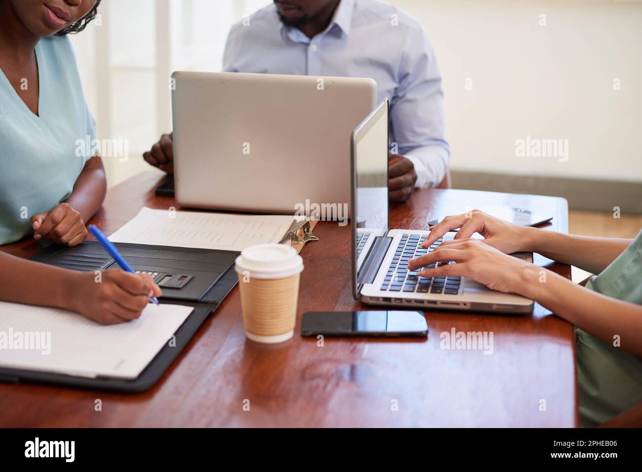 Hands multi ethnic team using hi-res stock photography and images - Alamy