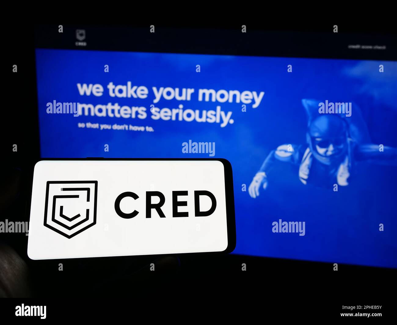 Person holding mobile phone with logo of company Dreamplug Technologies ...