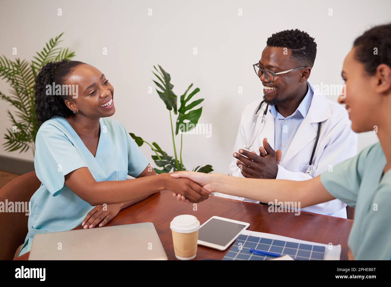 Young nurse shake hands hi-res stock photography and images - Alamy