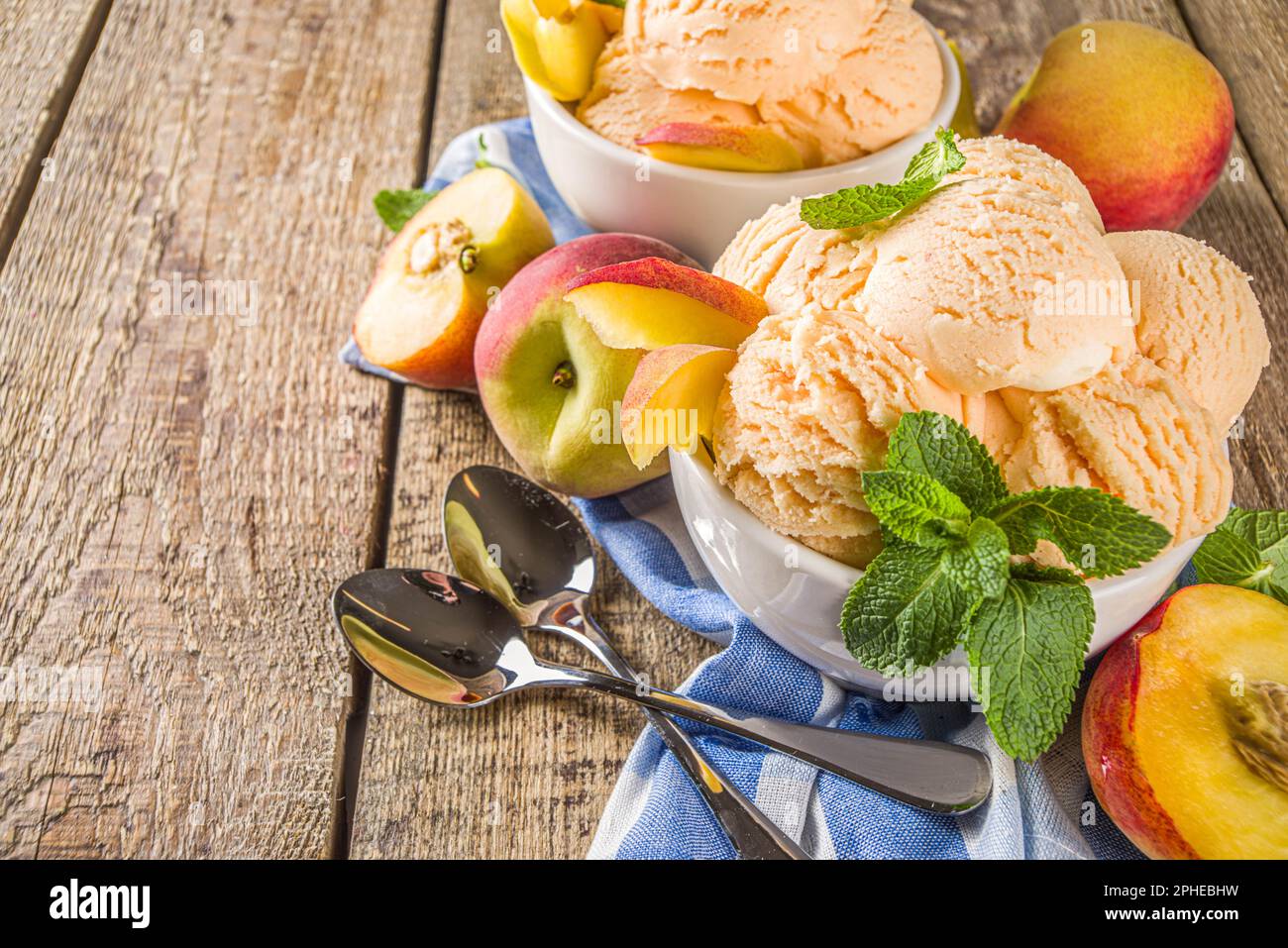 Homemade sweet peach ice cream. Peach gelato balls in small bowls, on ...