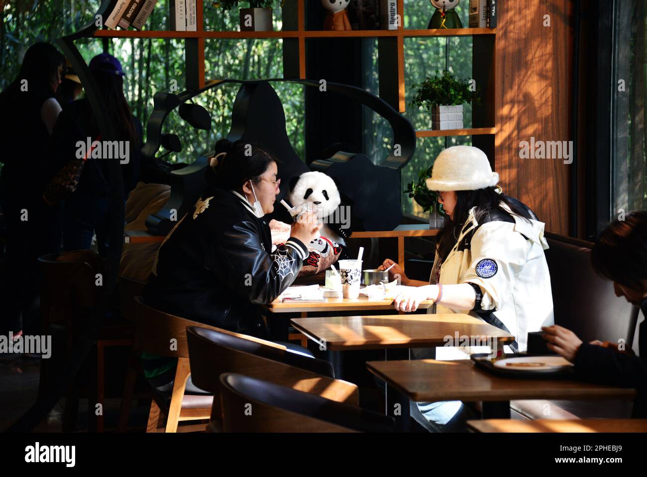 BEIJING, CHINA - MARCH 28, 2023 - Young people eat at the Panda Cafe on ...