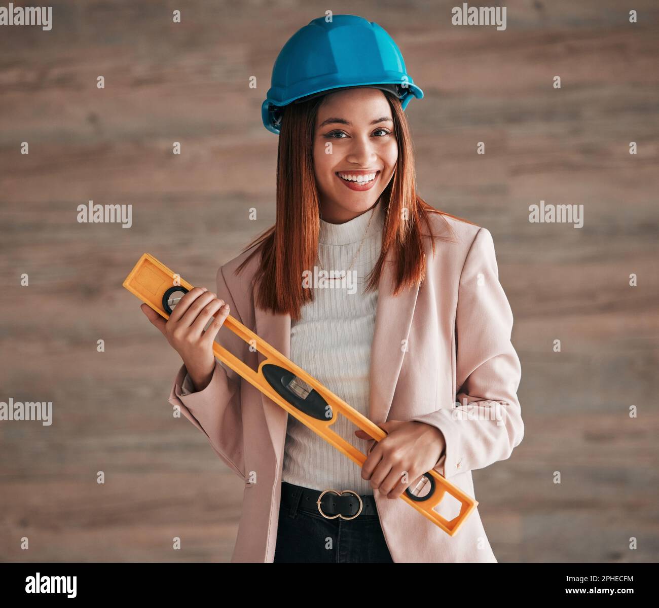 Architect, woman and portrait smile with level tool for measuring ...