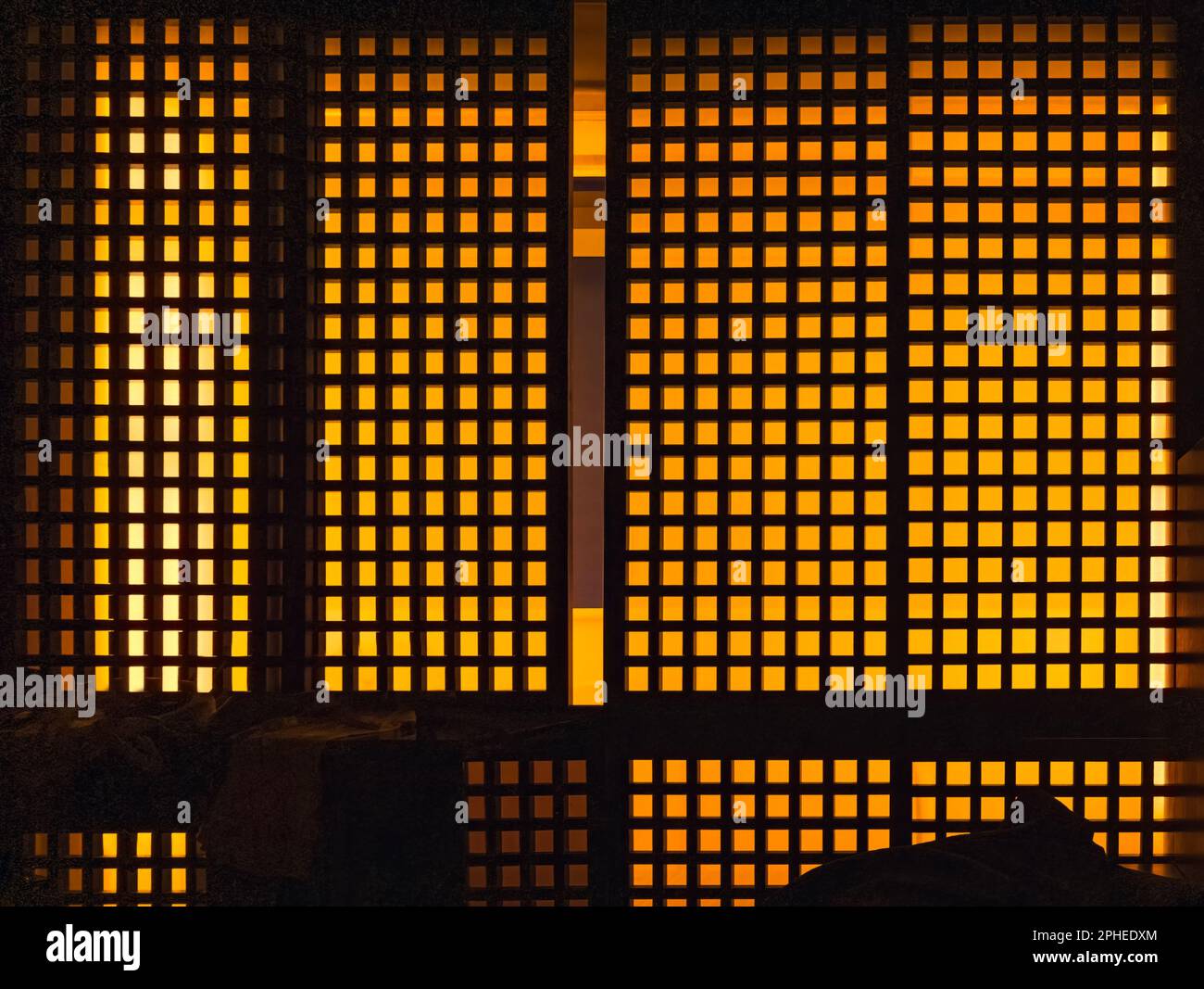 Window screens with bright glowing lights reflecting on surface in ...