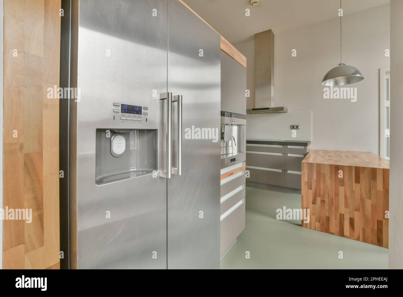 Interior of modern kitchen with minimalist cabinets refrigerator and ...