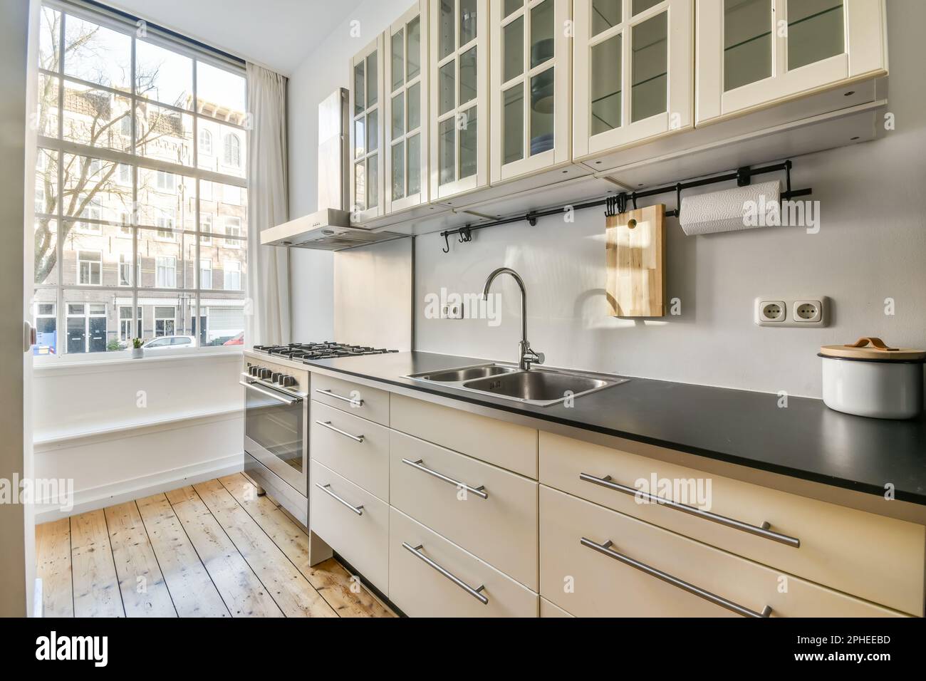 Interior design of contemporary kitchen with glass window furnished ...
