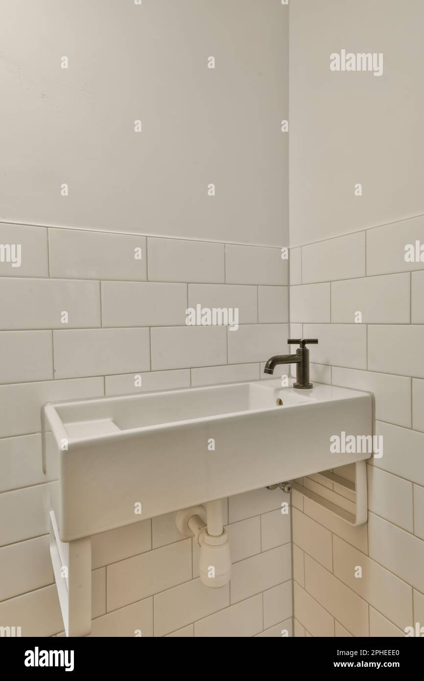 Interior design of modern lavatory with white ceramic small sink and ...