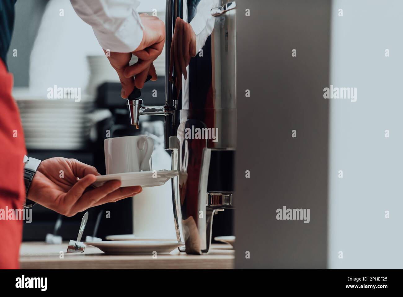 The waiter preparing coffee for hotel guests. Close up photo of service ...