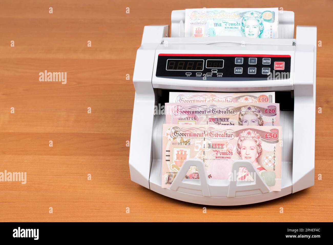 Gibraltar money, older serie of pounds in the counting machine Stock ...