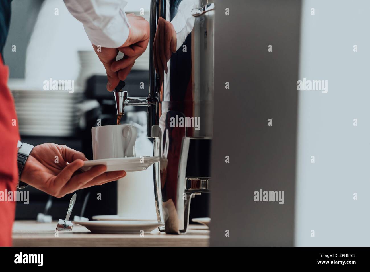 The waiter preparing coffee for hotel guests. Close up photo of service ...