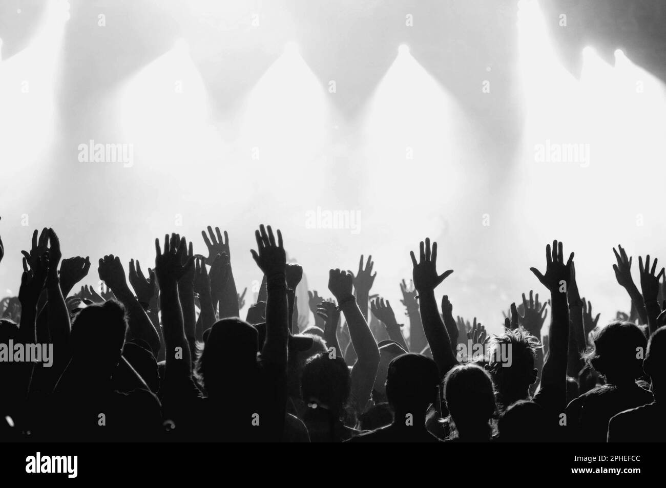 Crop hands of anonymous people having fun on magnificent music show ...