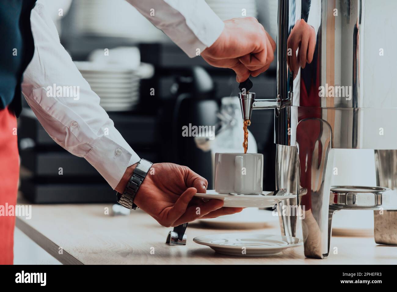 The waiter preparing coffee for hotel guests. Close up photo of service ...